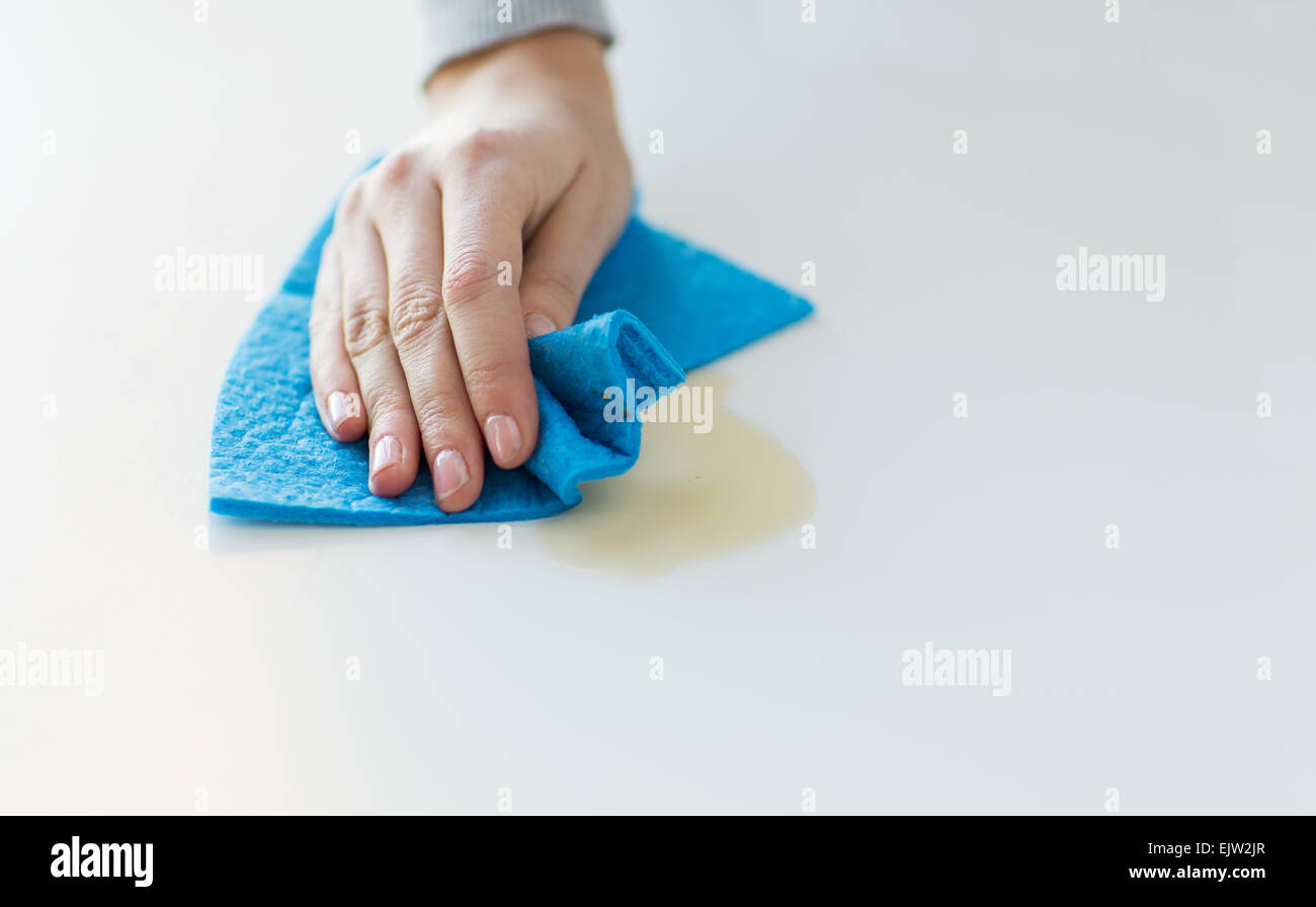 close up of hand cleaning table surface with cloth Stock Photo - Alamy