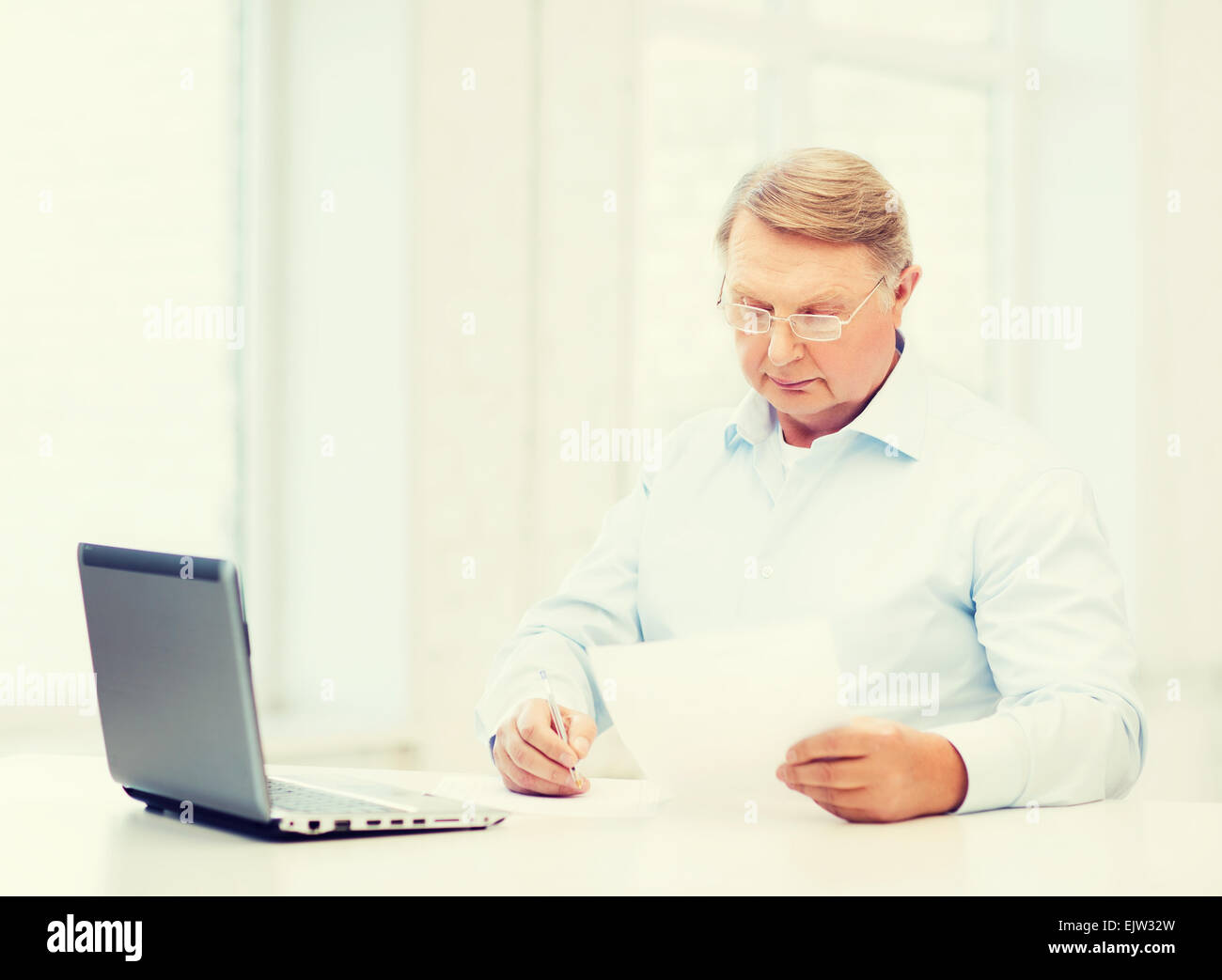 old man in eyeglasses filling a form at home Stock Photo - Alamy