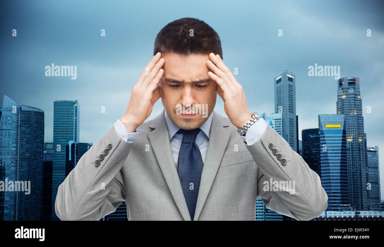 Businessman having headache touching head hi-res stock photography and ...