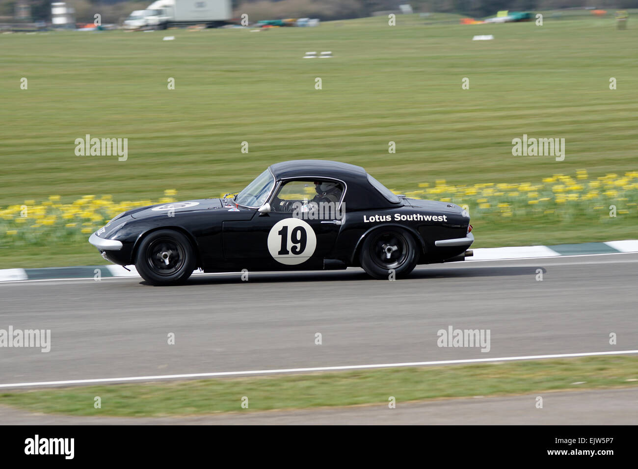 The Lotus 26R of Mark Midgley and C Woodgate cornering hard at the ...