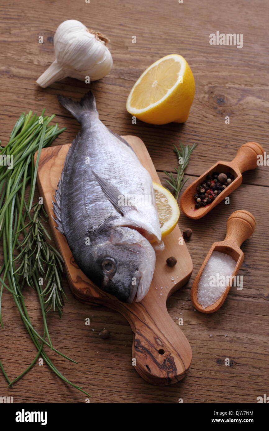 Sea Bream with ingredients on cutting board, top view Stock Photo - Alamy