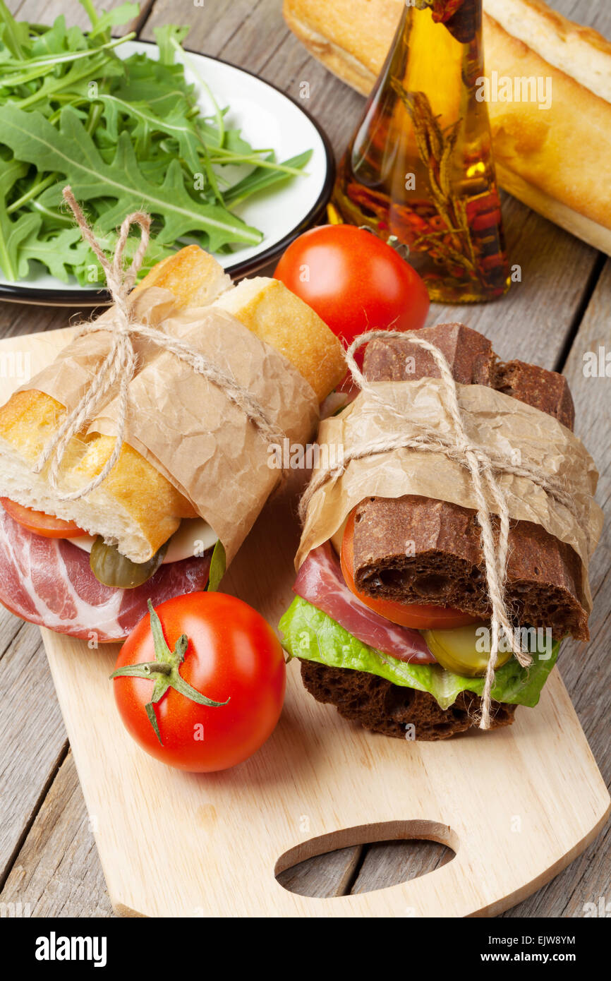 Sandwiches and salad on wooden table. Top view Stock Photo - Alamy