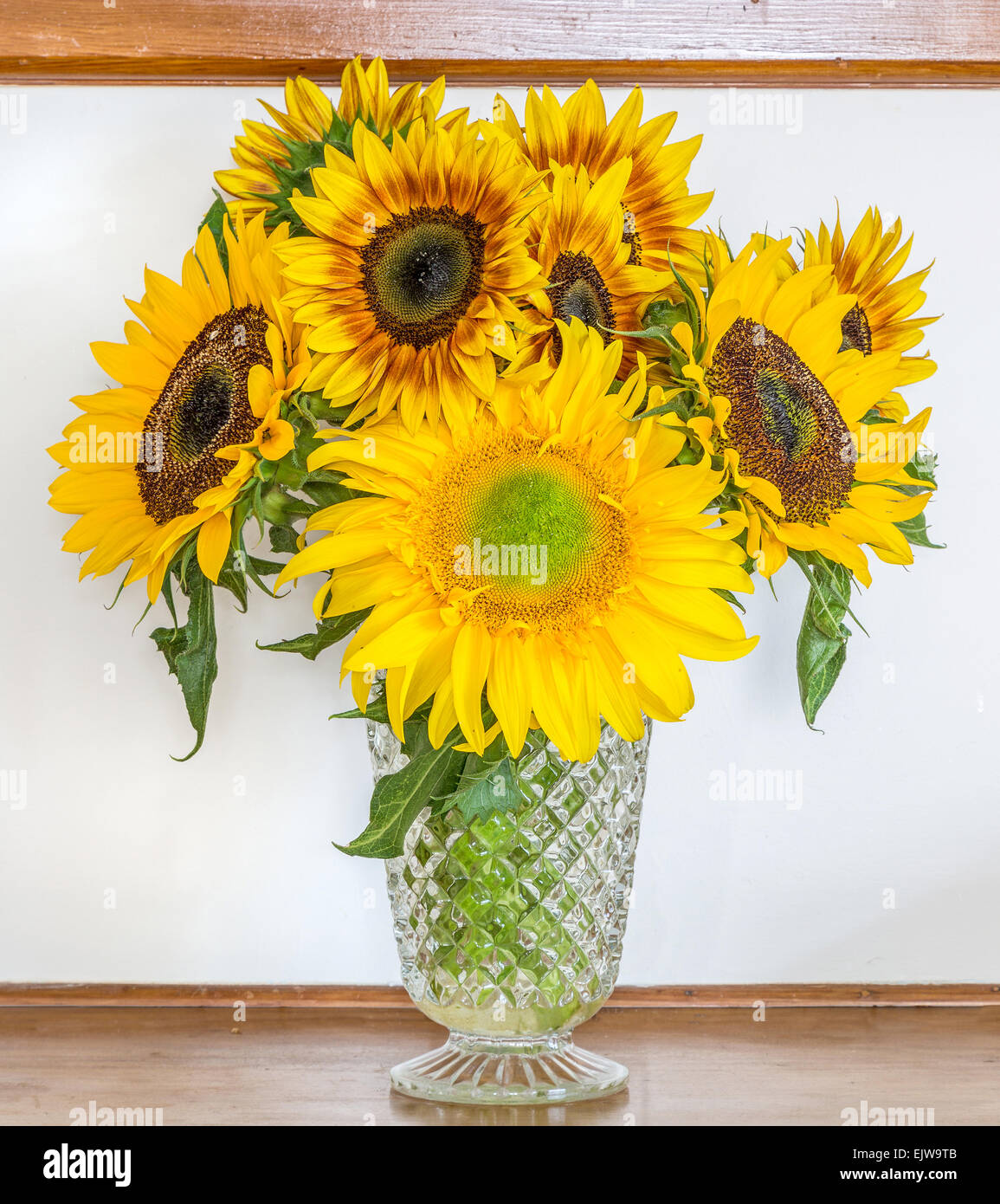 A bouquet of sunflowers in an ornate glass antique vase Stock Photo - Alamy