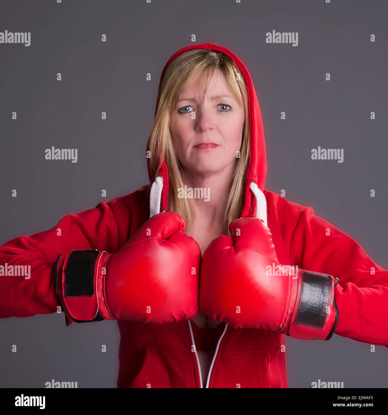 Woman fighting fit and wearing red boxing gloves and jacket Stock Photo ...