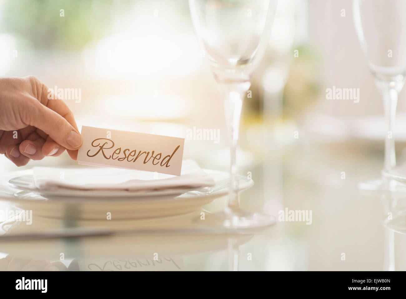 Close up of man's hand setting place in restaurant Stock Photo - Alamy