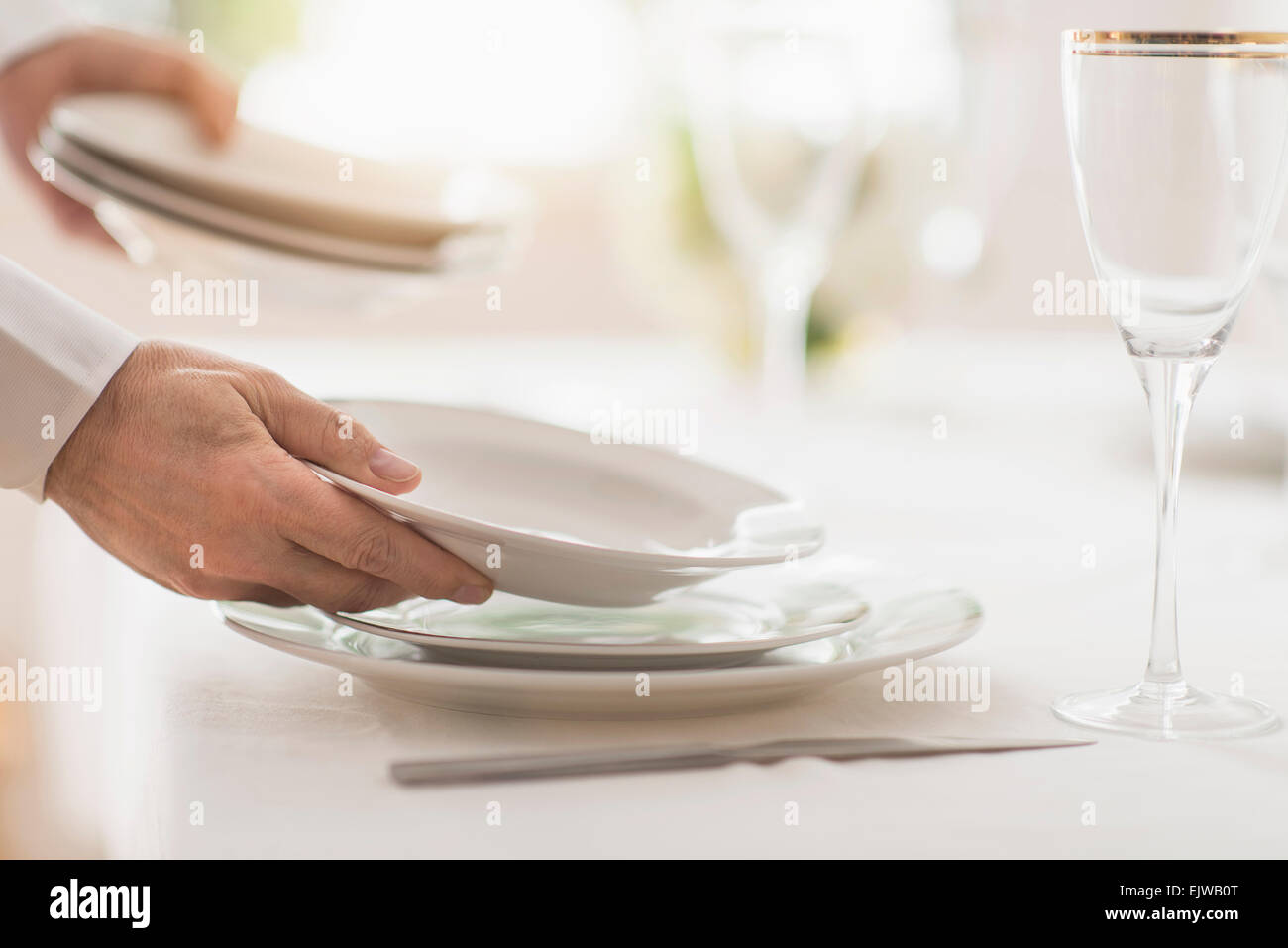 Close up of man's hand setting place in restaurant Stock Photo - Alamy