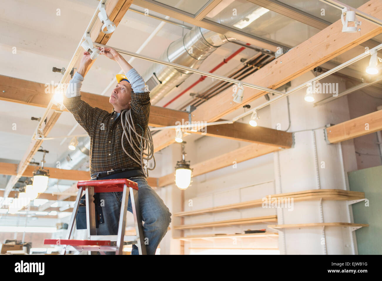Man ladder fixing cables hi-res stock photography and images - Alamy