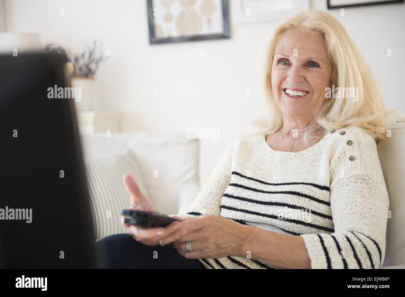 Woman Holding Remote Control High Resolution Stock Photography and ...