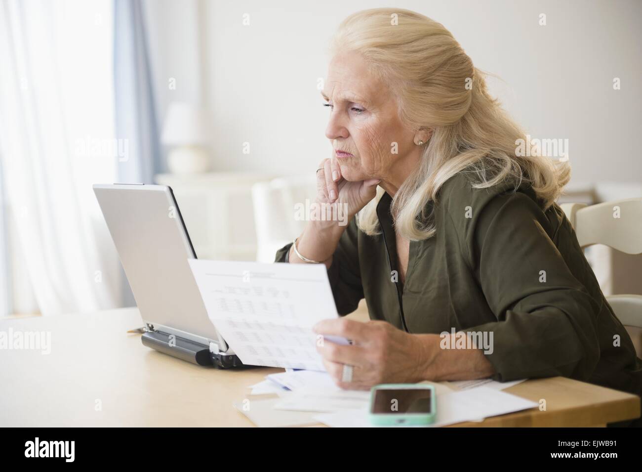 Senior woman paying bills online Stock Photo - Alamy