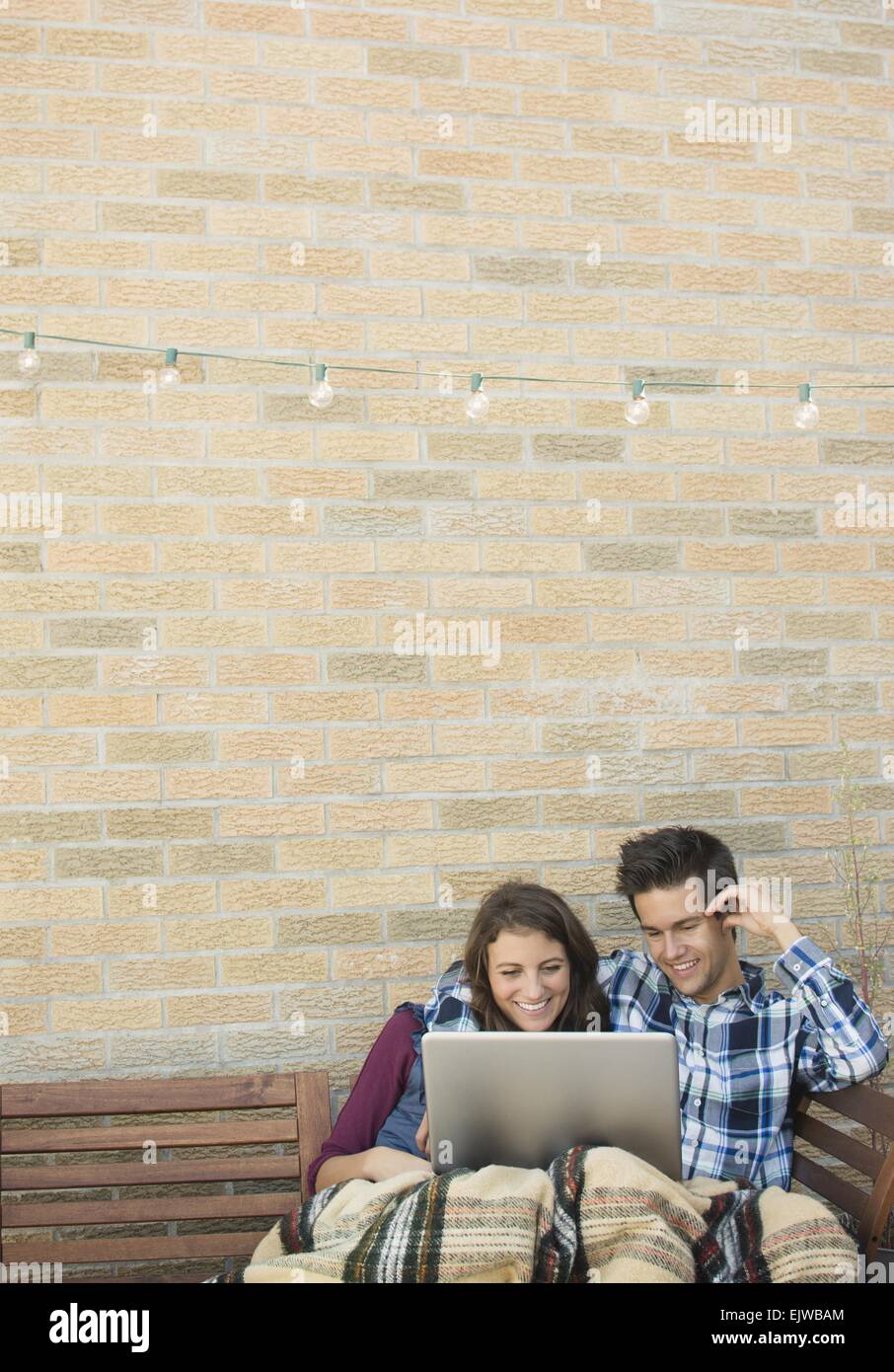 USA, New York State, New York City, Brooklyn, Young couple using laptop ...