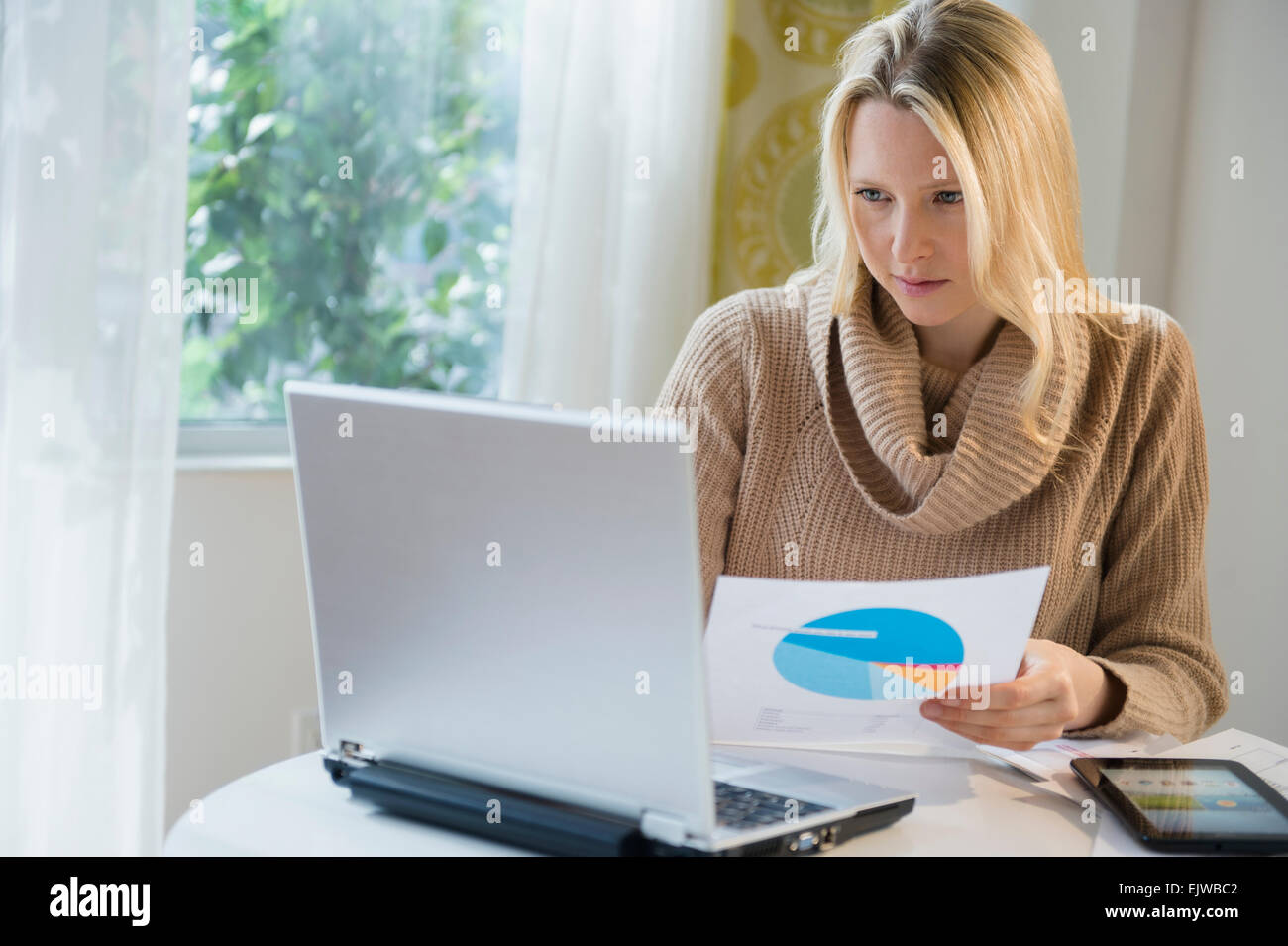 Blond woman working from home Stock Photo - Alamy