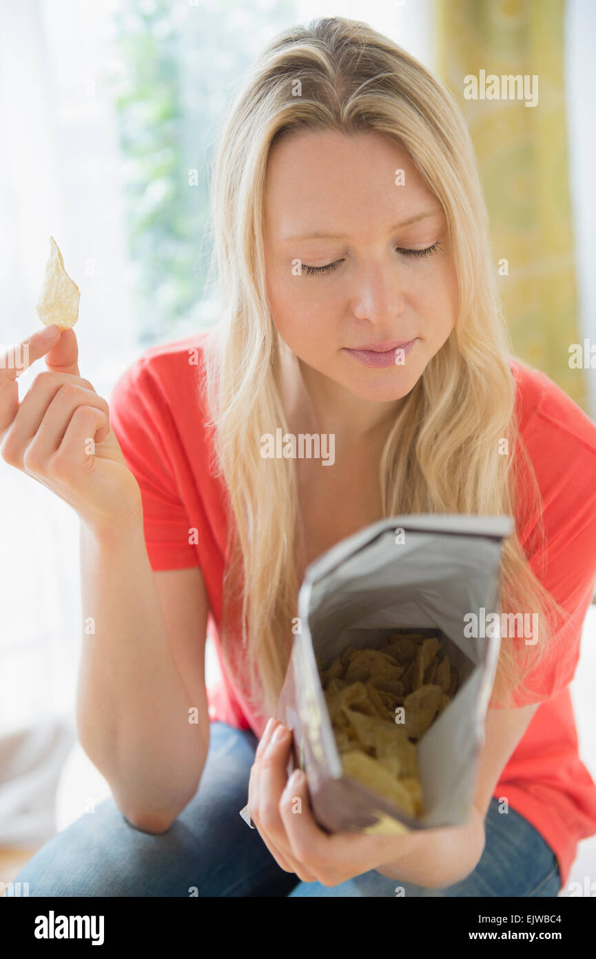 Woman sitting holding chips hi-res stock photography and images - Alamy