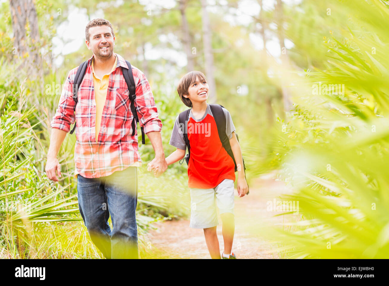Father And His Son Walking Together Holding Hands Hi Res Stock