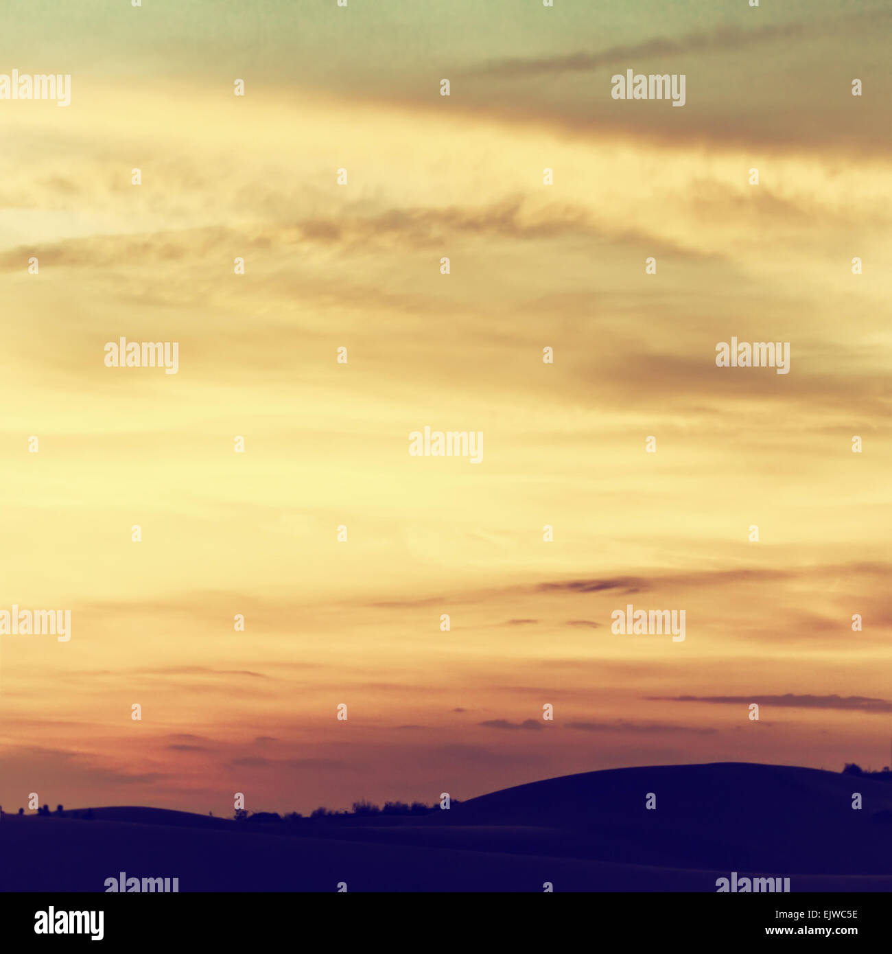 Beautiful sky with clouds at sunset. Filtered image Stock Photo - Alamy