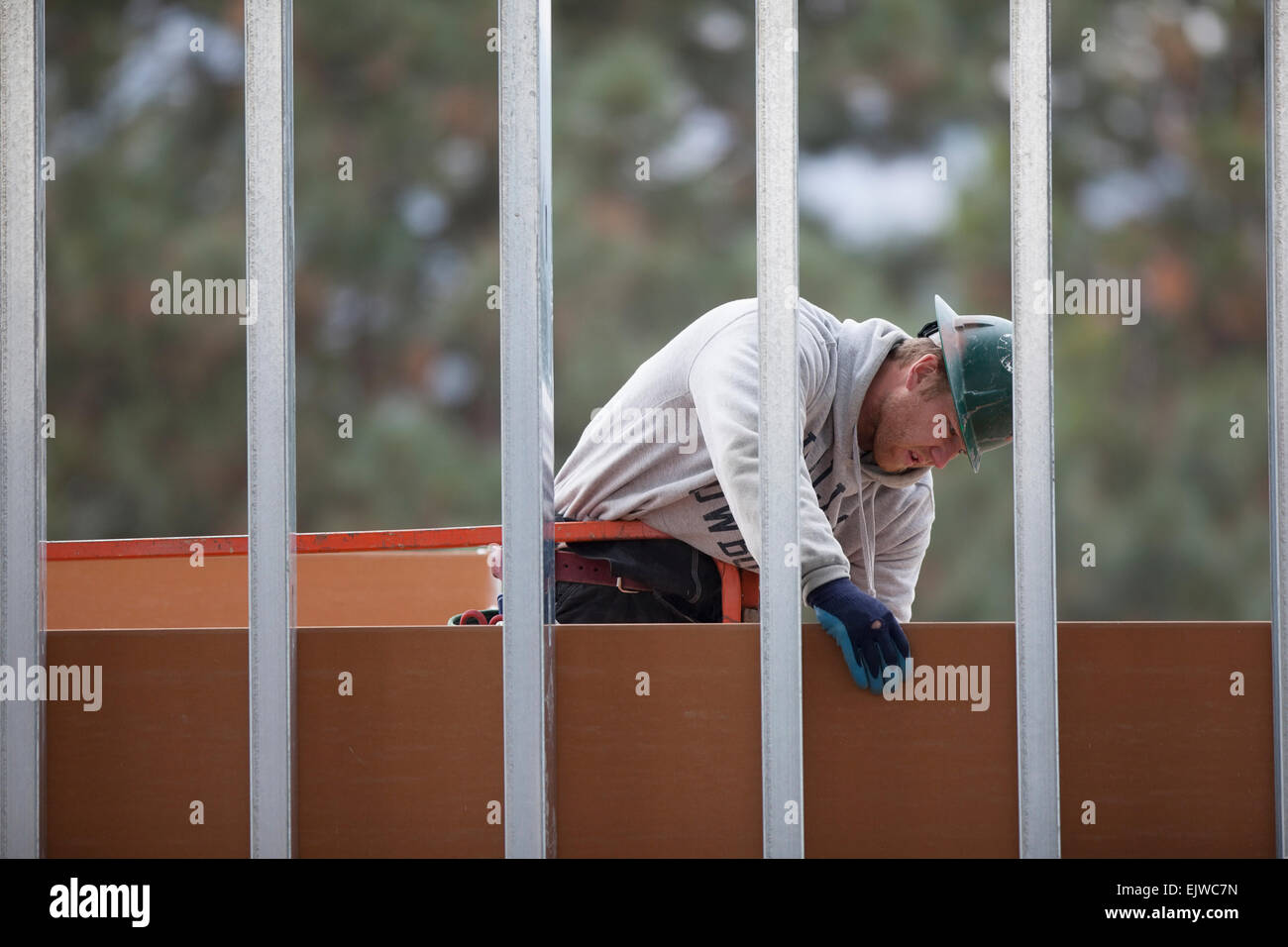USA, Montana, Kalispell, Man working at construction site Stock Photo ...