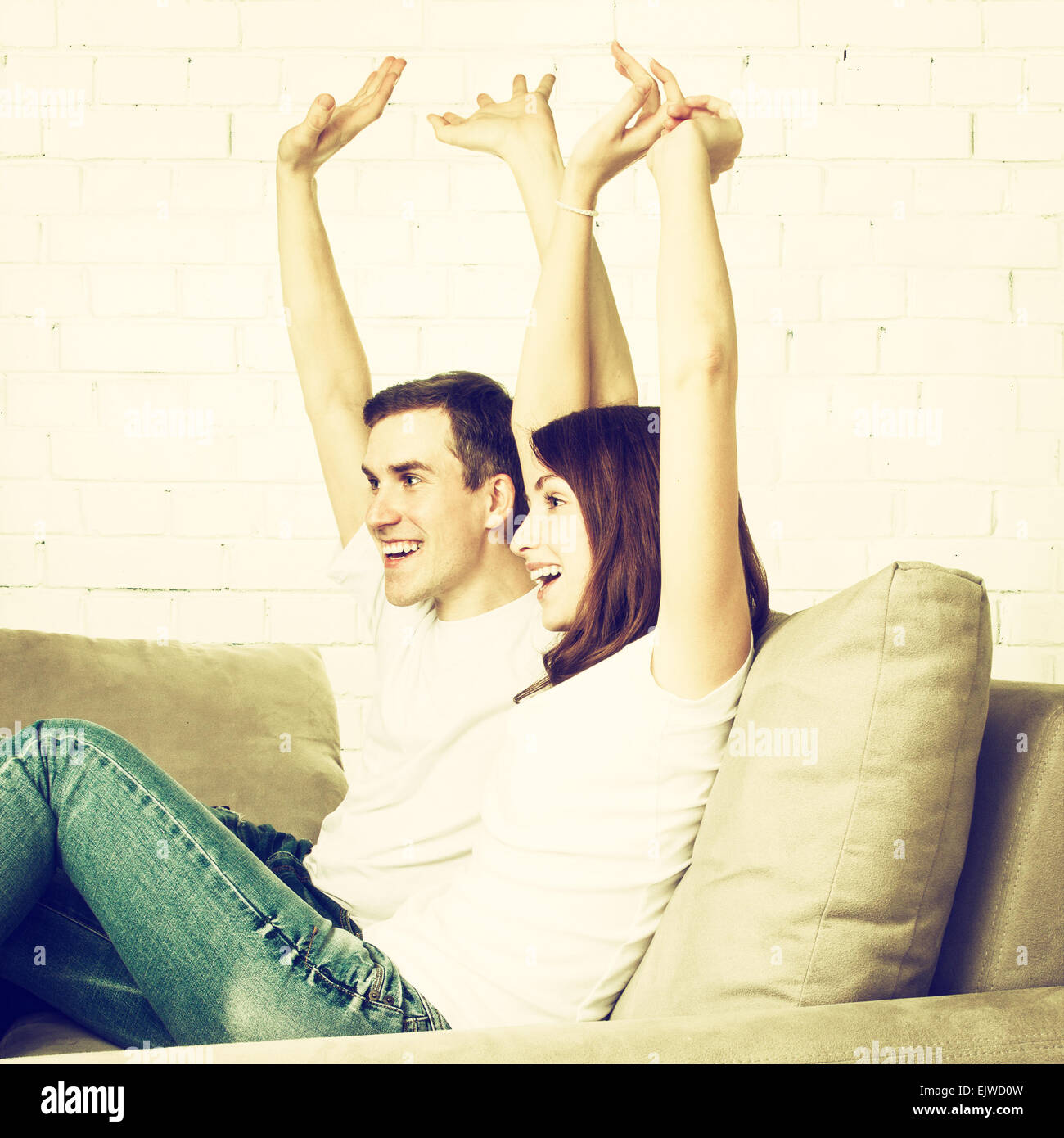 Happy couple with arms raised up Stock Photo - Alamy