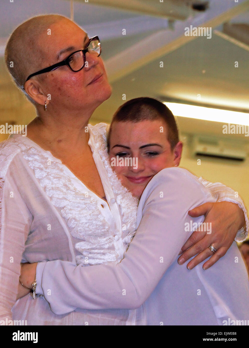 A girl has her head shaved for a cancer charity to show her support ...