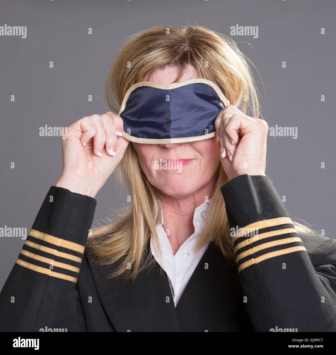 Sleepy aircrew officer using an eye shade Stock Photo - Alamy