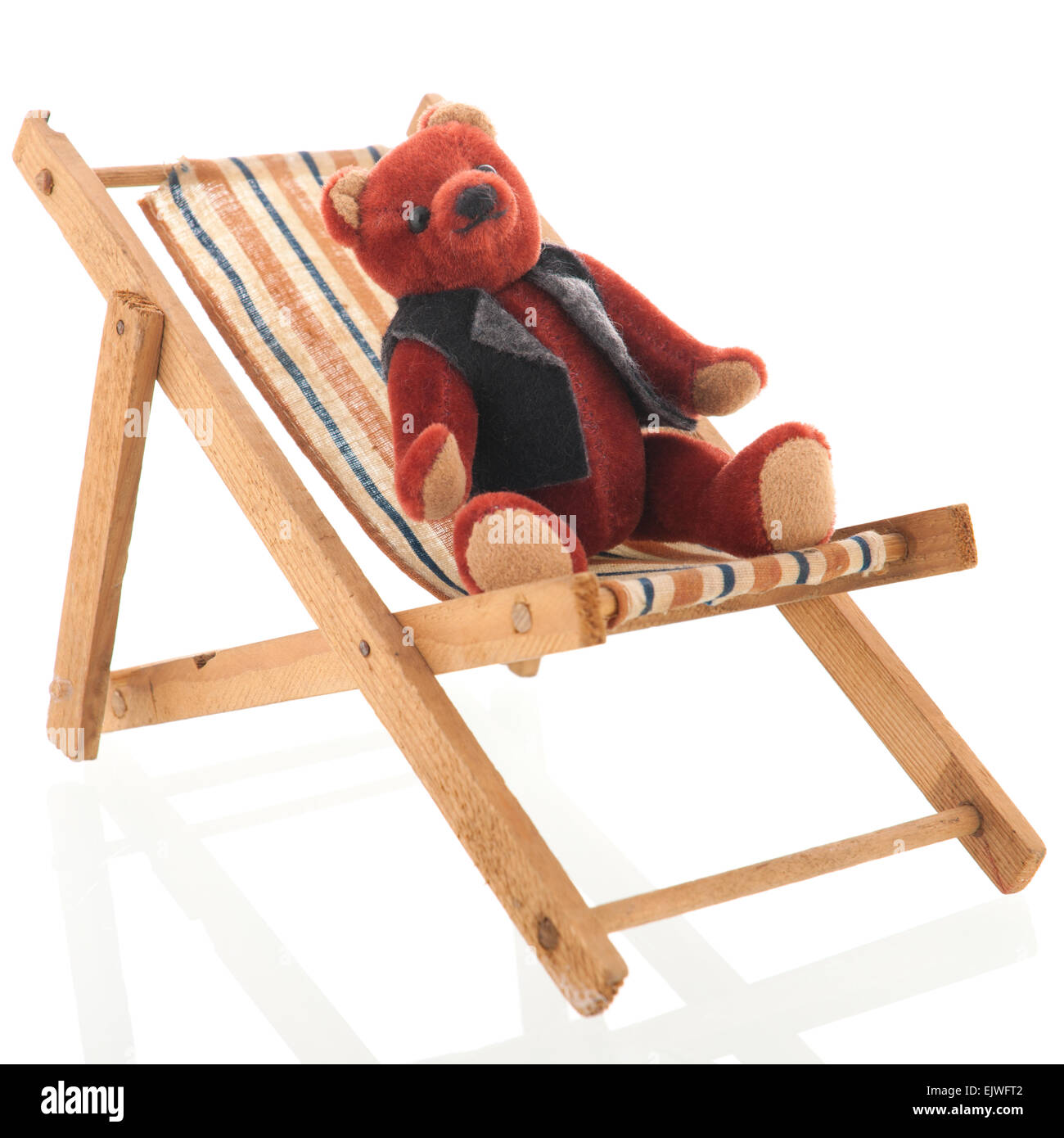 Stuffed hand made vintage bear in beach chair isolated over white ...