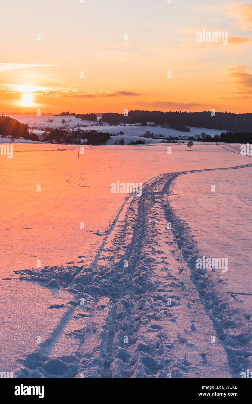 Landscape with trail on snow at sunset Stock Photo - Alamy
