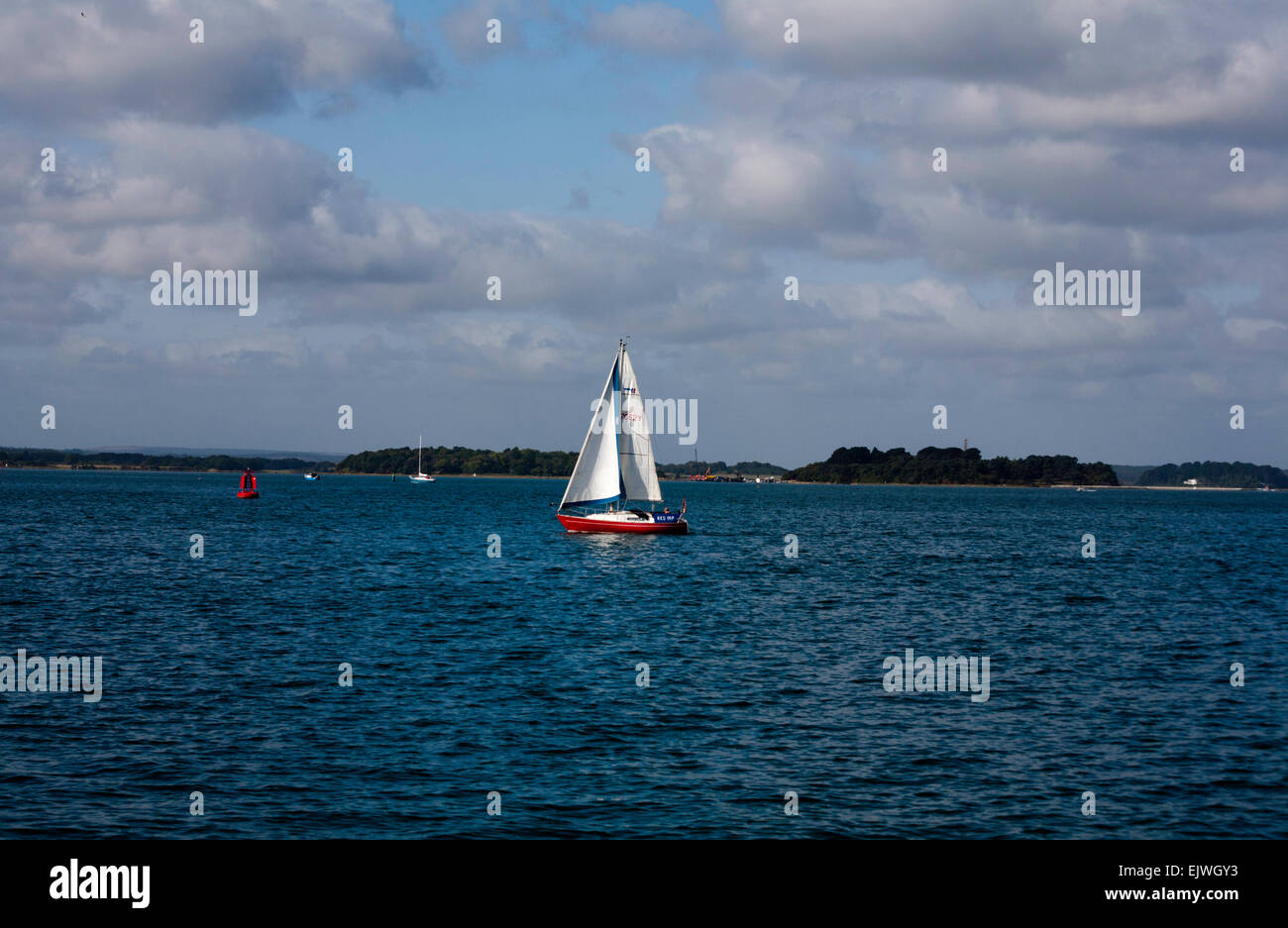 Yacht sailing near Sandbanks and Shell Bay at the entrance to Poole ...