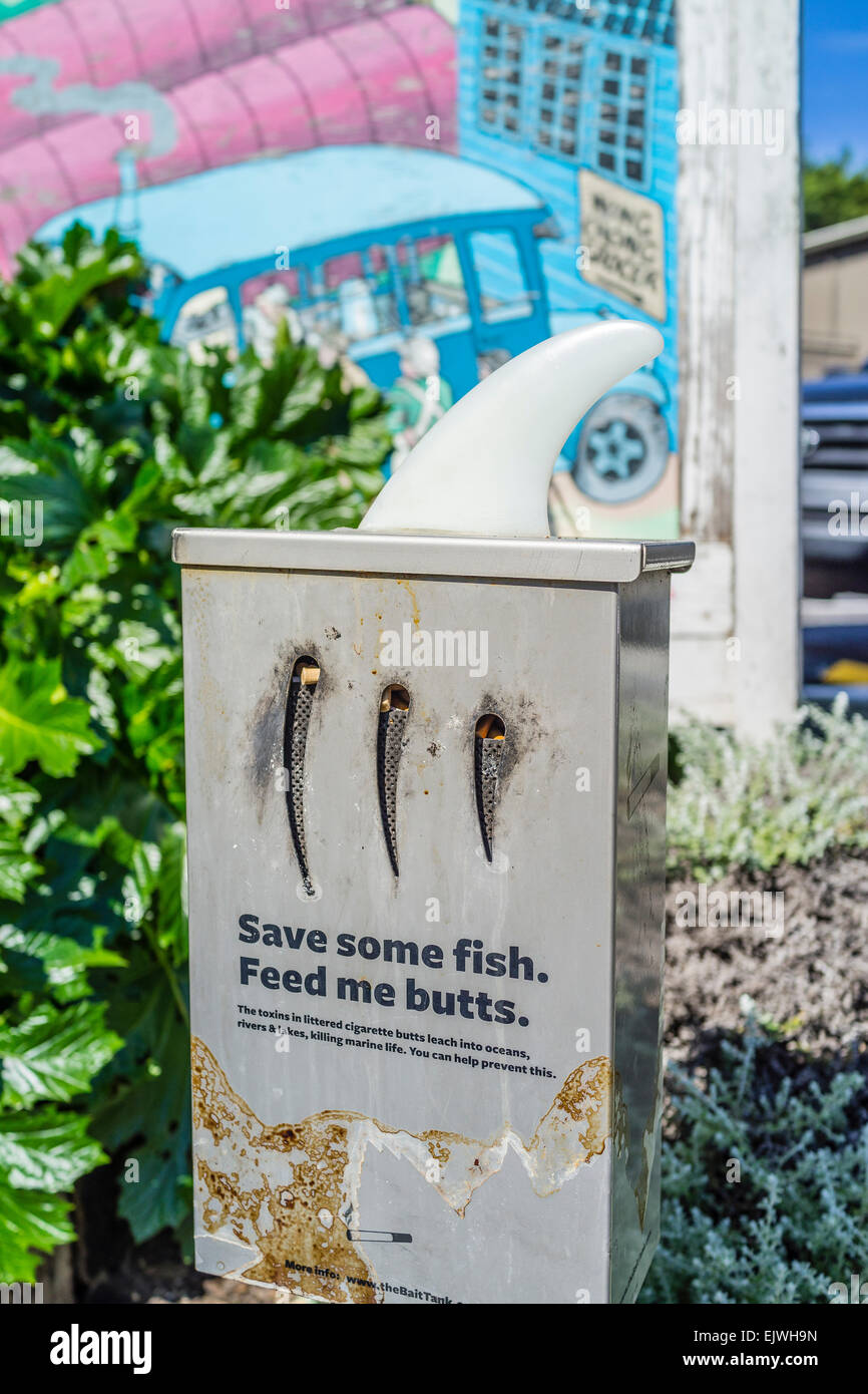 A sliver colored metal box topped by a black shark's fin on a pole on a ...