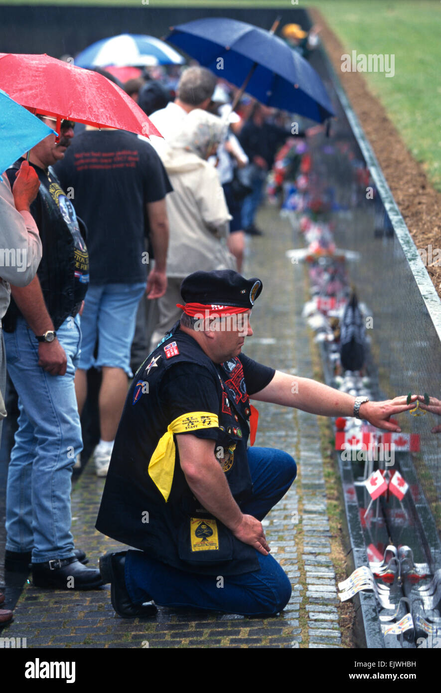 A military veteran pauses in honor of fallen comrades at the Vietnam Veterans Memorial during ...