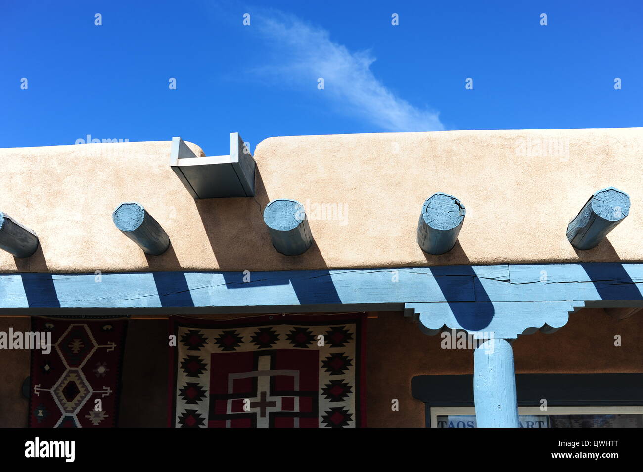 USA New Mexico NM Taos detail of an adobe structure with rain gutter ...