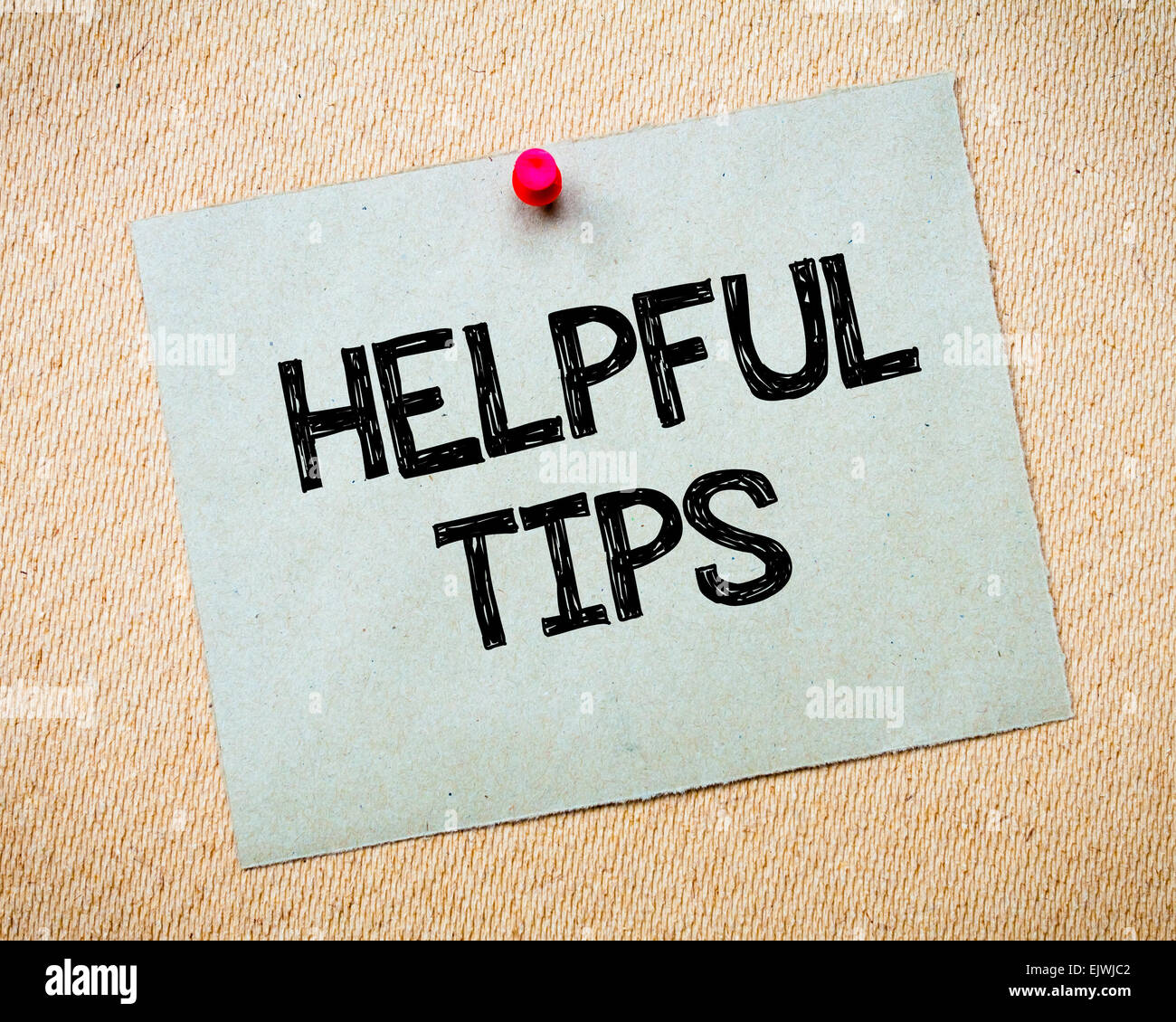Recycled paper note pinned on cork board. Helpful Tips Message. Concept ...
