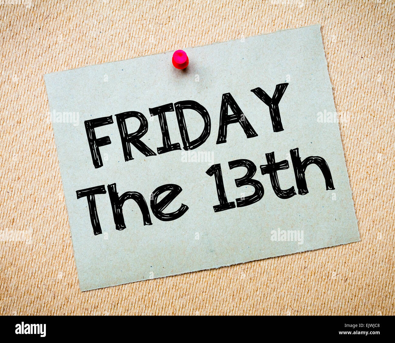 Recycled paper note pinned on cork board. Friday the13th Message ...