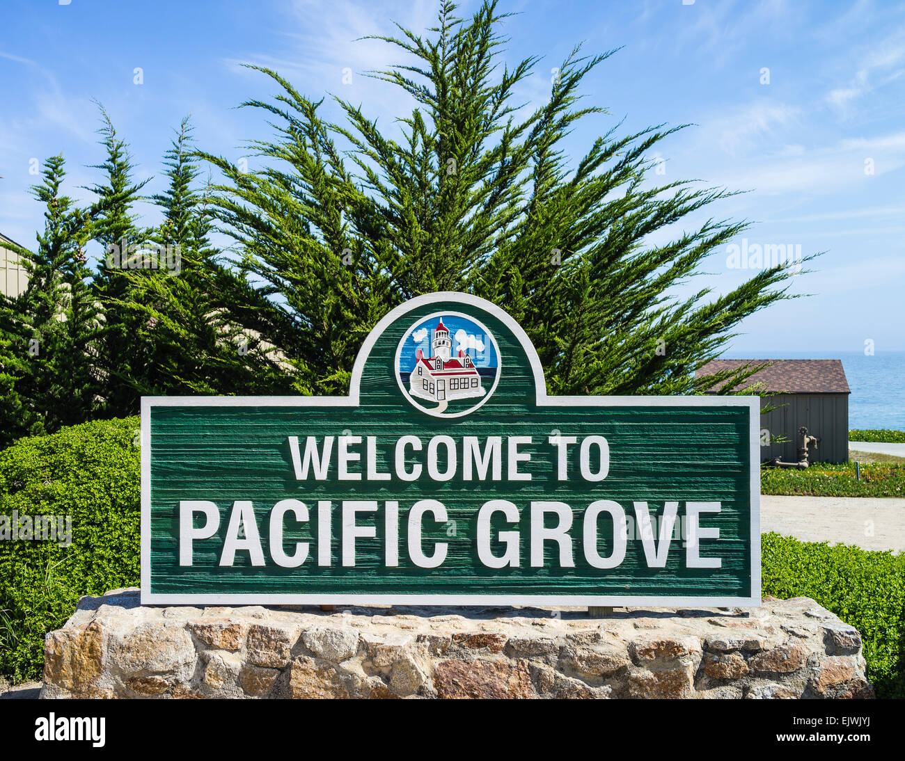 A handcrafted wooden and painted green and white sign that welcomes ...