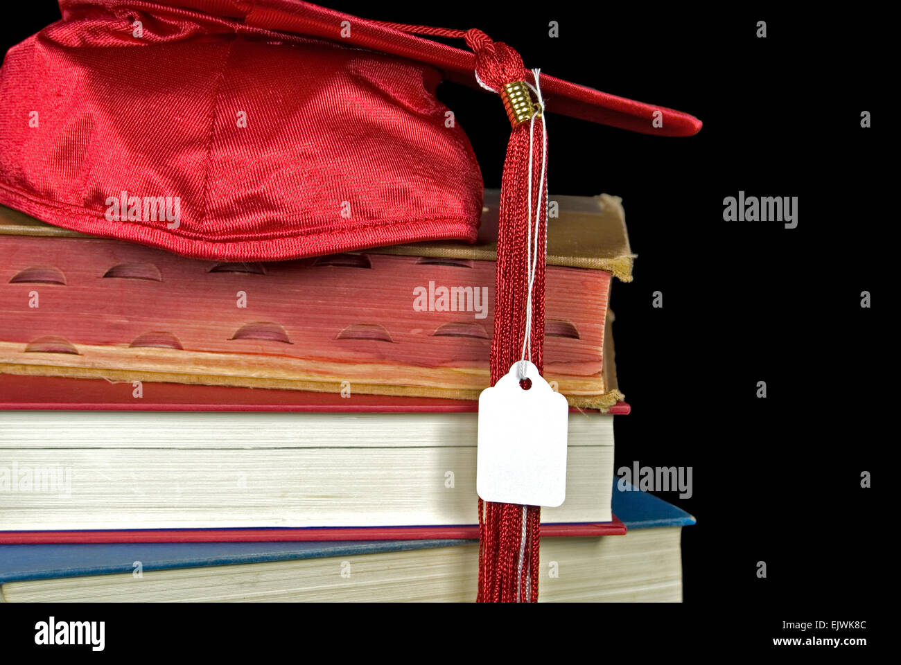 Price tag on red graduation cap on stack of books Stock Photo - Alamy