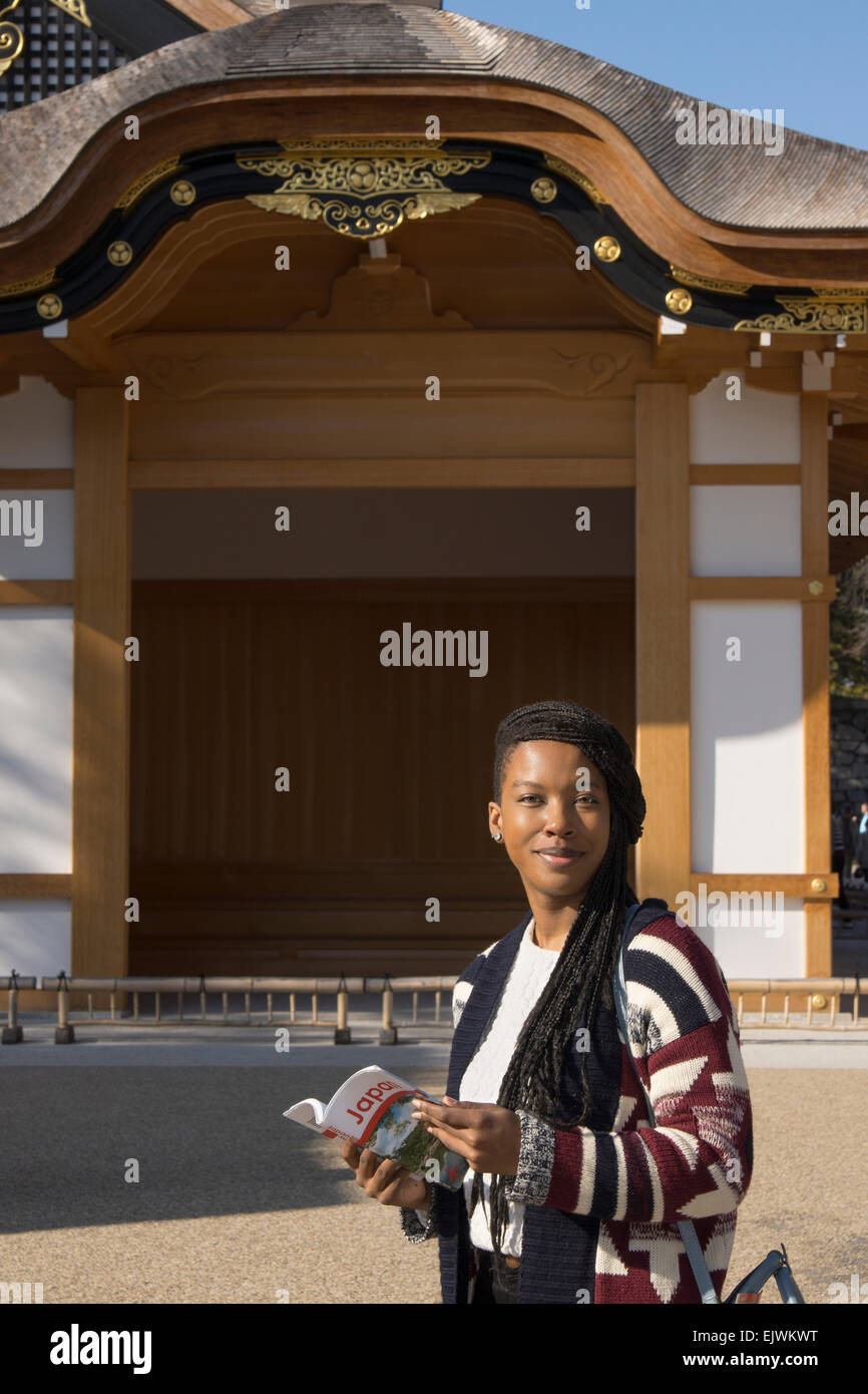 A young lady traveling in Japan outside of the palace part of Nagoya ...