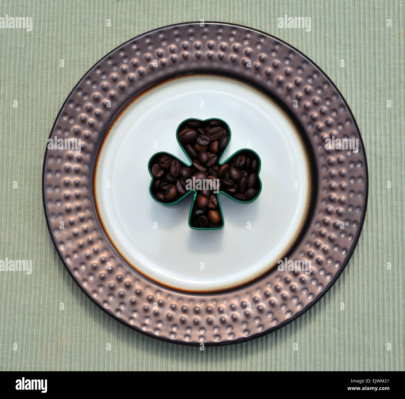 Clover shape of coffee beans on a decorative plate Stock Photo - Alamy