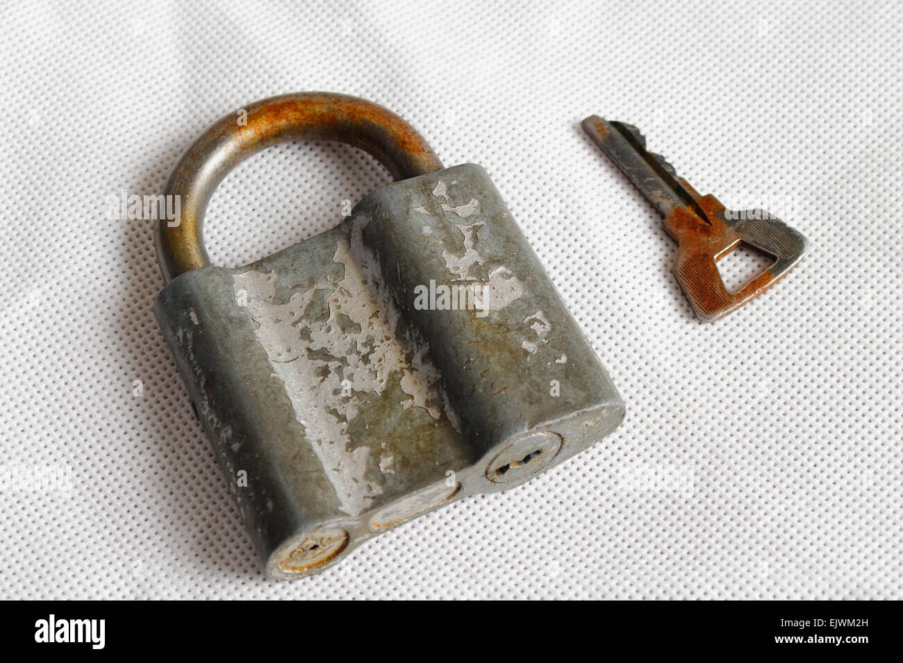 closed old rusty padlock with a key Stock Photo - Alamy