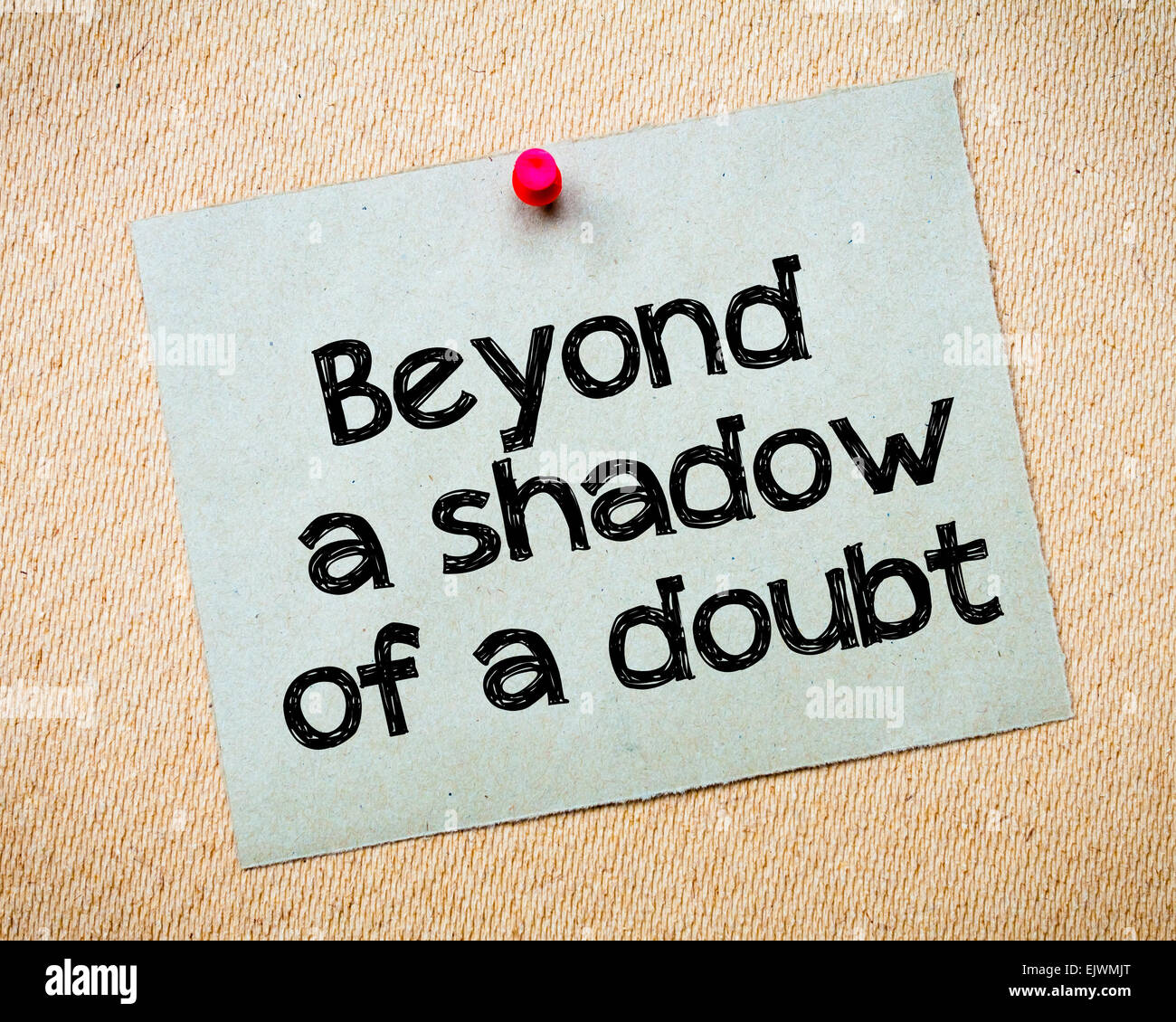 Beyond a shadow of a doubt Message. Recycled paper note pinned on cork ...