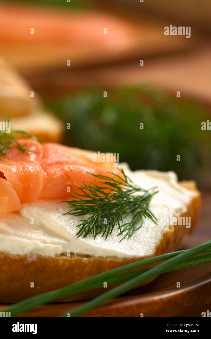 Canape of smoked salmon and cream cheese on wholewheat bun garnished ...