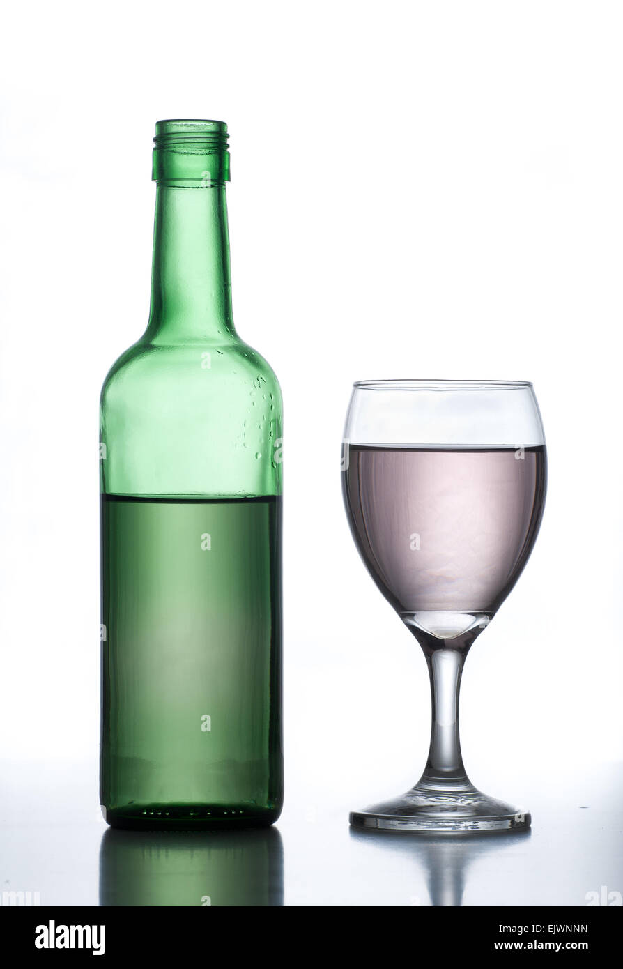 Wine glass and bottle on reflective surface with white background Stock ...