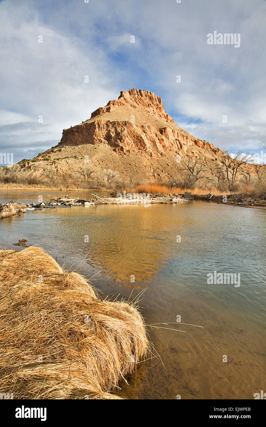 The Chama River flows beneath rugged cliffs of colored earth near the ...