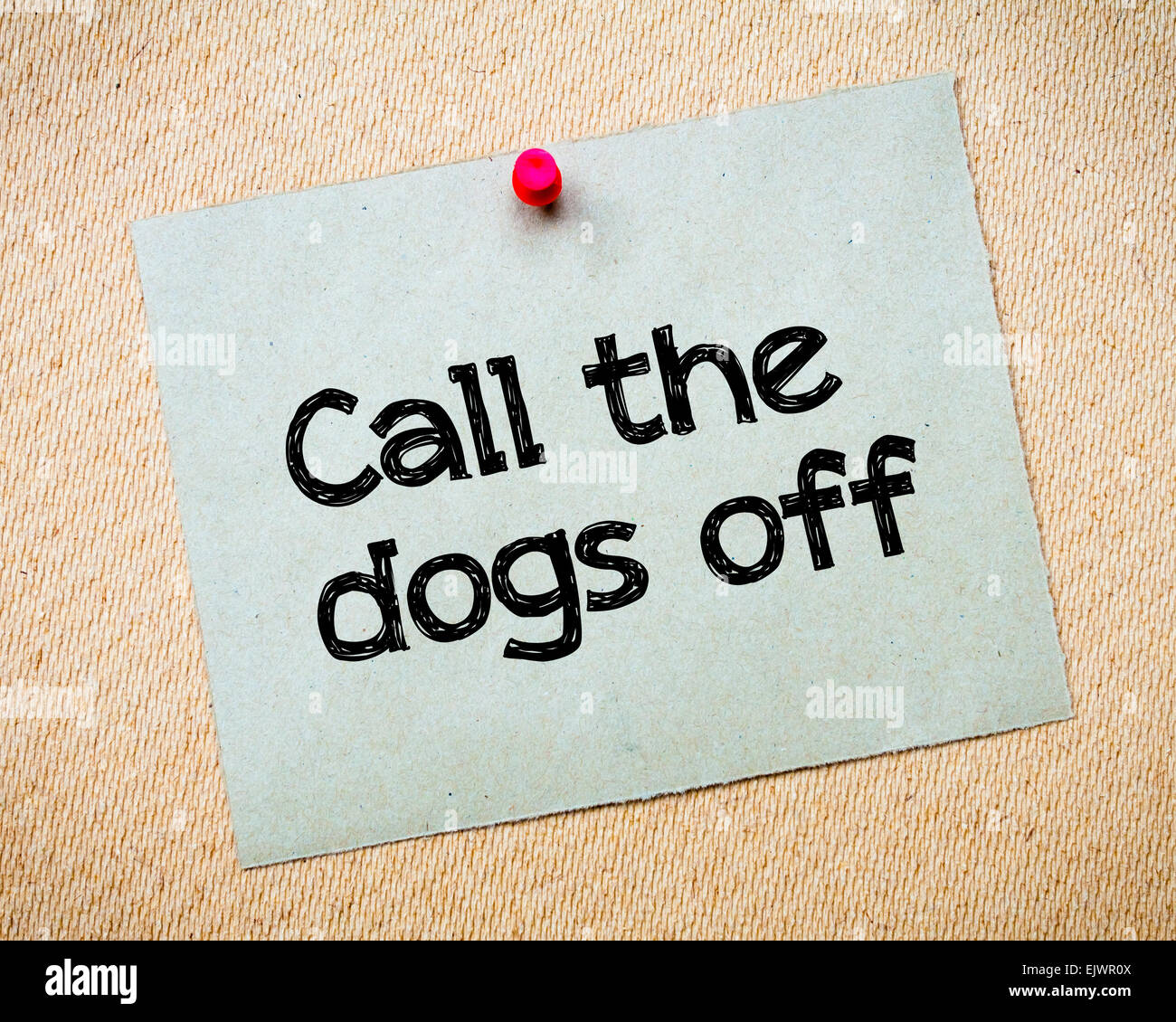 Call the dogs off Message. Recycled paper note pinned on cork board ...