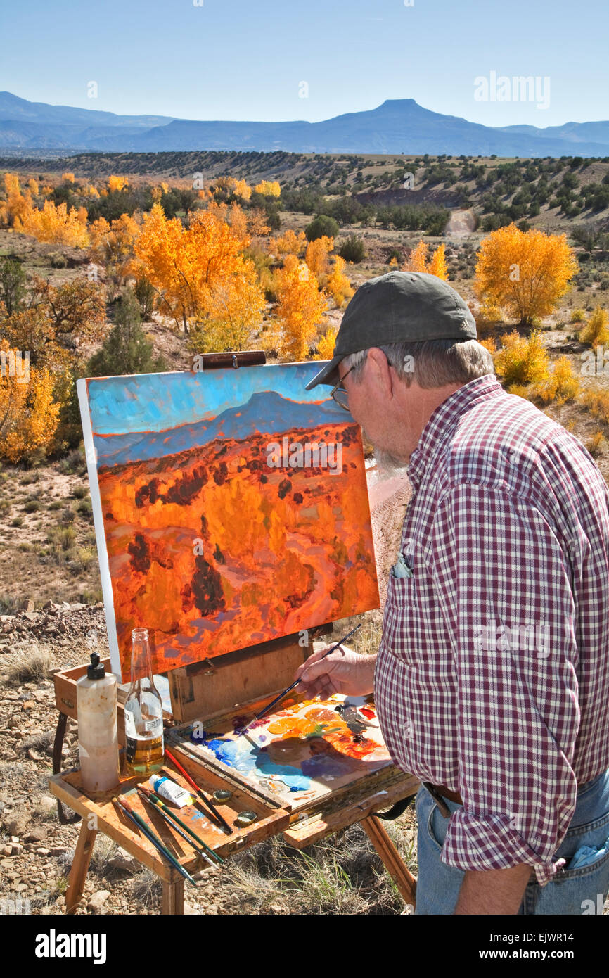 Painter Barry McCuen works on a plein air canvas of the fall colors in ...