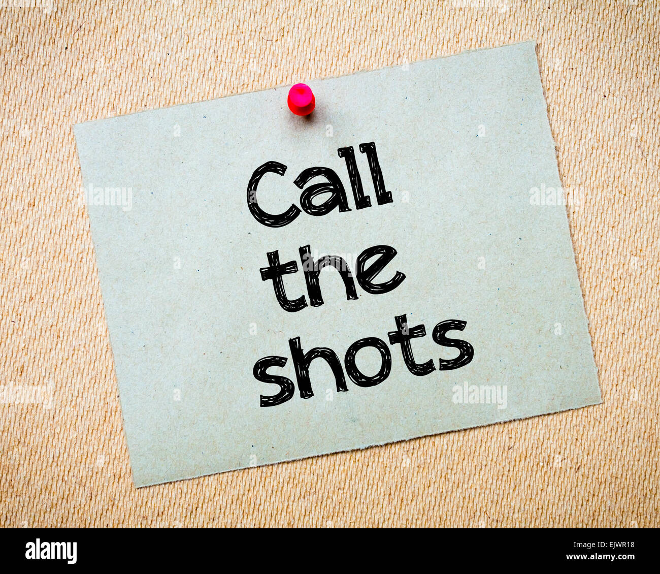 Call the shots Message. Recycled paper note pinned on cork board ...