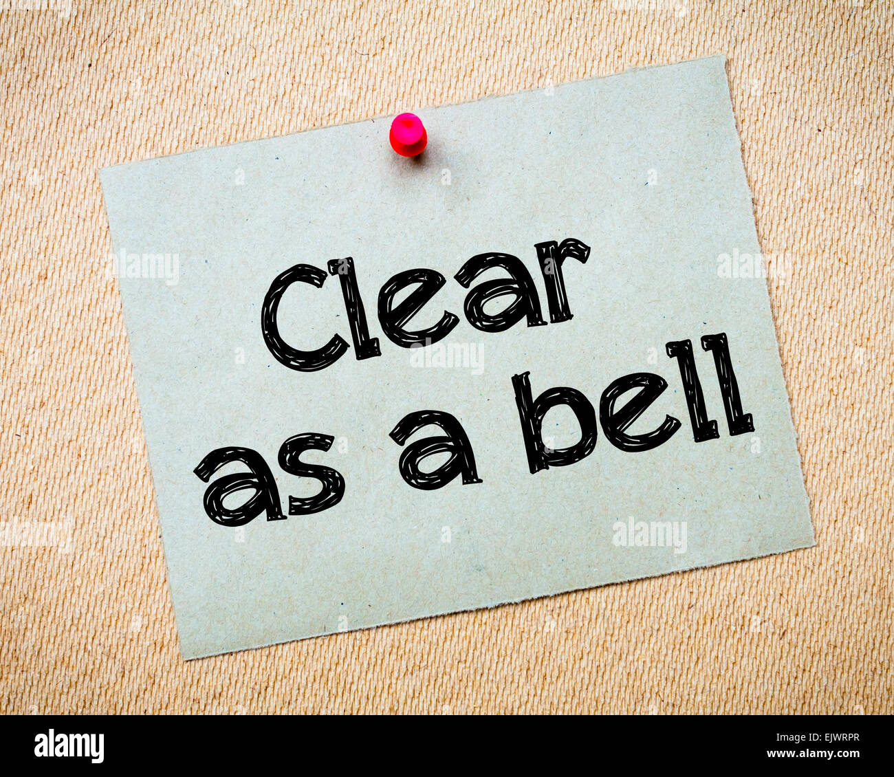 Clear as a bell Message. Recycled paper note pinned on cork board ...
