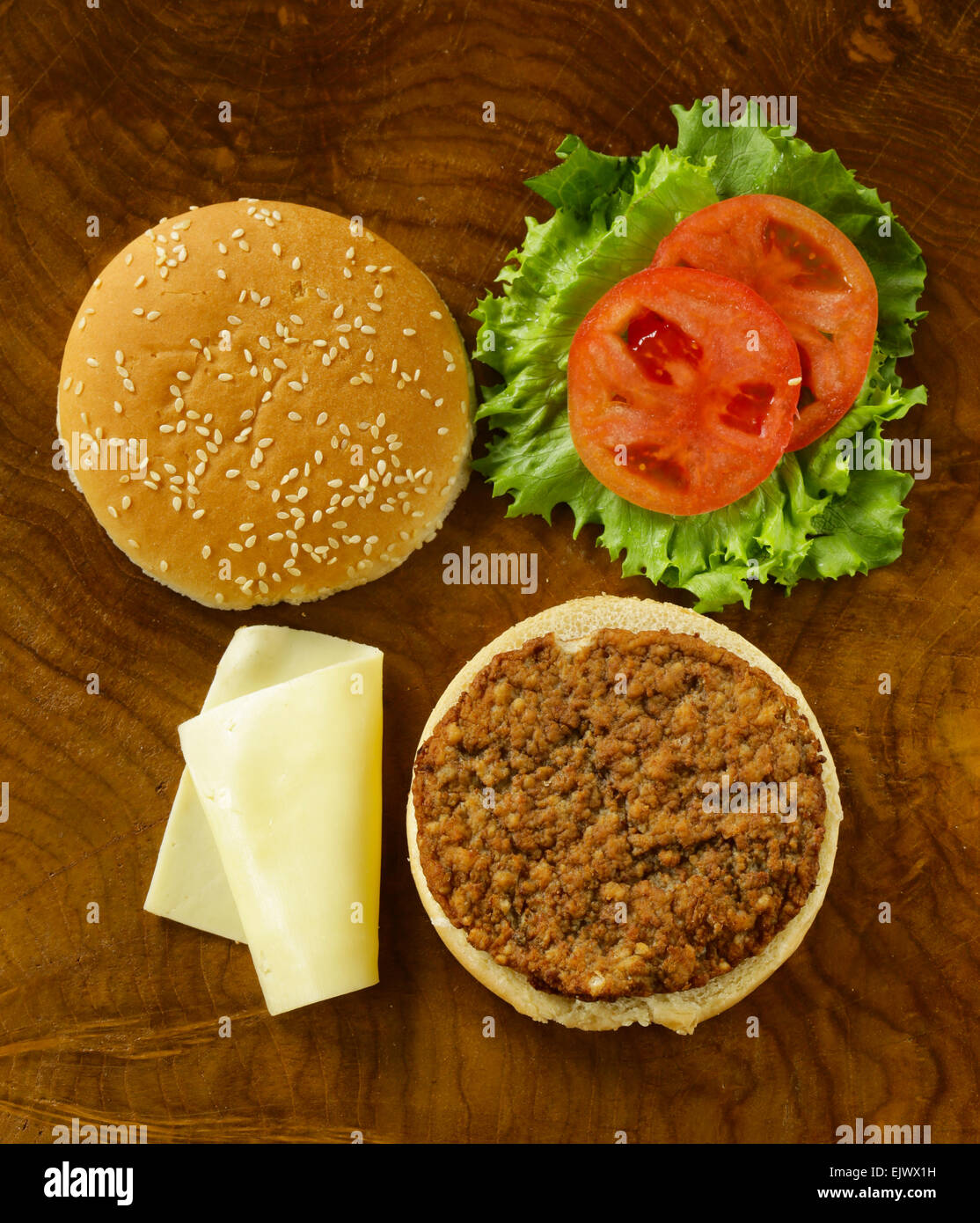 traditional cheeseburger with green lettuce and tomatoes Stock Photo ...