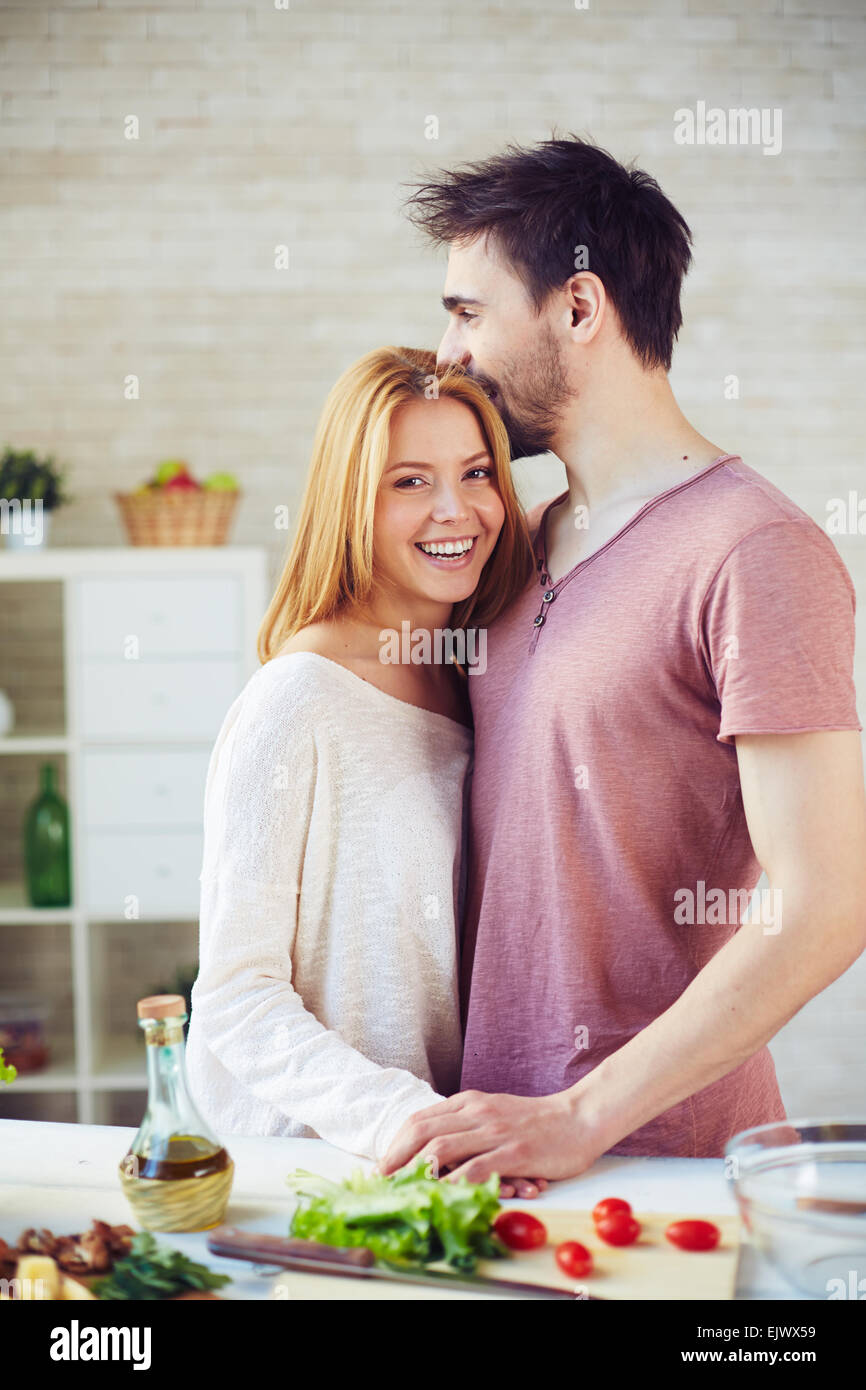 Happy and amorous dates standing by table with vegetarian food Stock ...