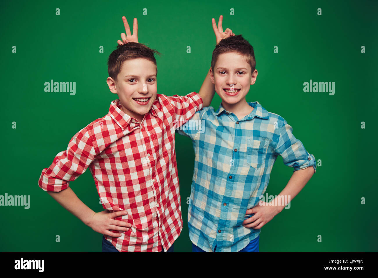 Smiling twins making fun of one another Stock Photo - Alamy