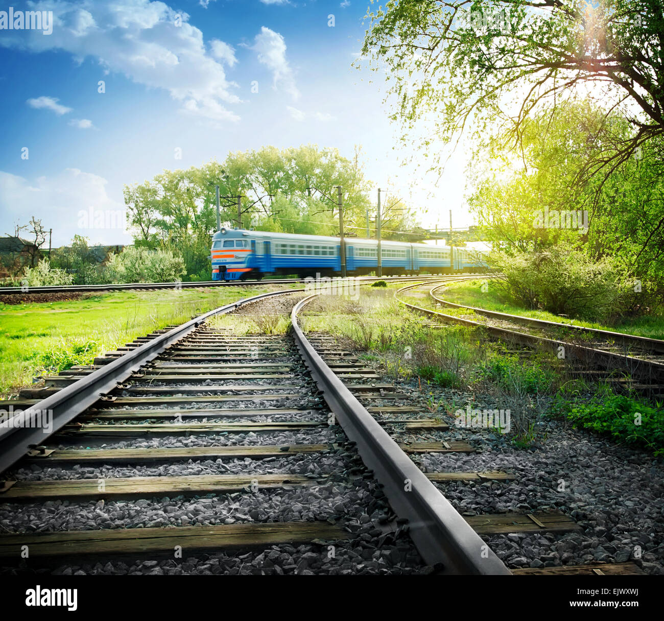 Railroad with train against the bright sun Stock Photo - Alamy