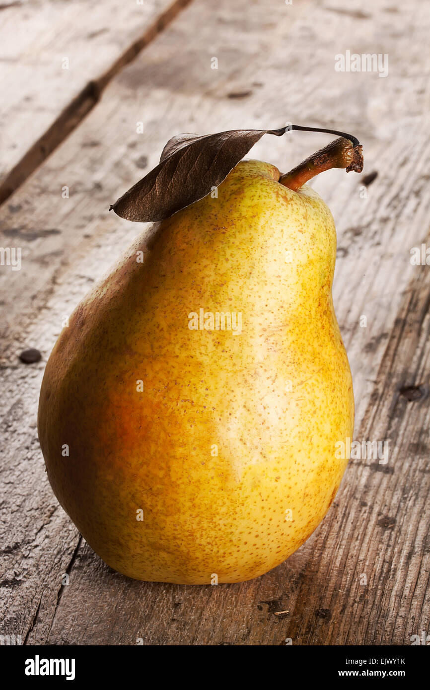 Bright yellow juicy pear on wooden background Stock Photo - Alamy