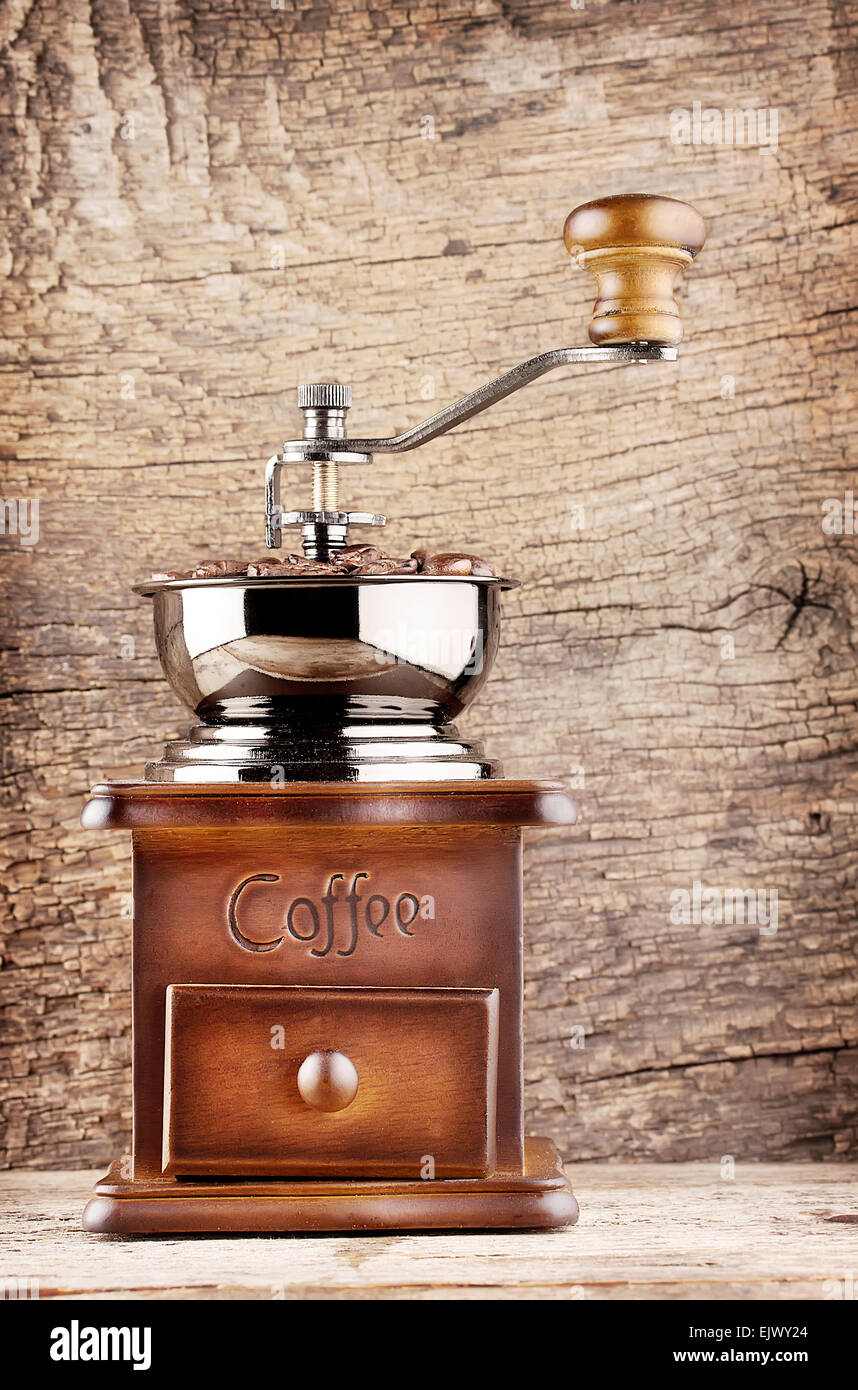 Coffee grinder with a handle on the wooden background Stock Photo - Alamy