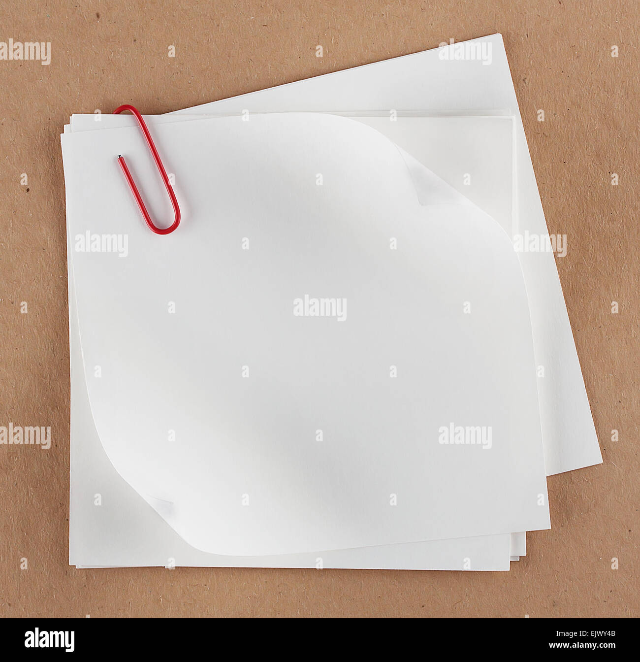 Stack of white stickers with a clip on cardboard background Stock Photo ...